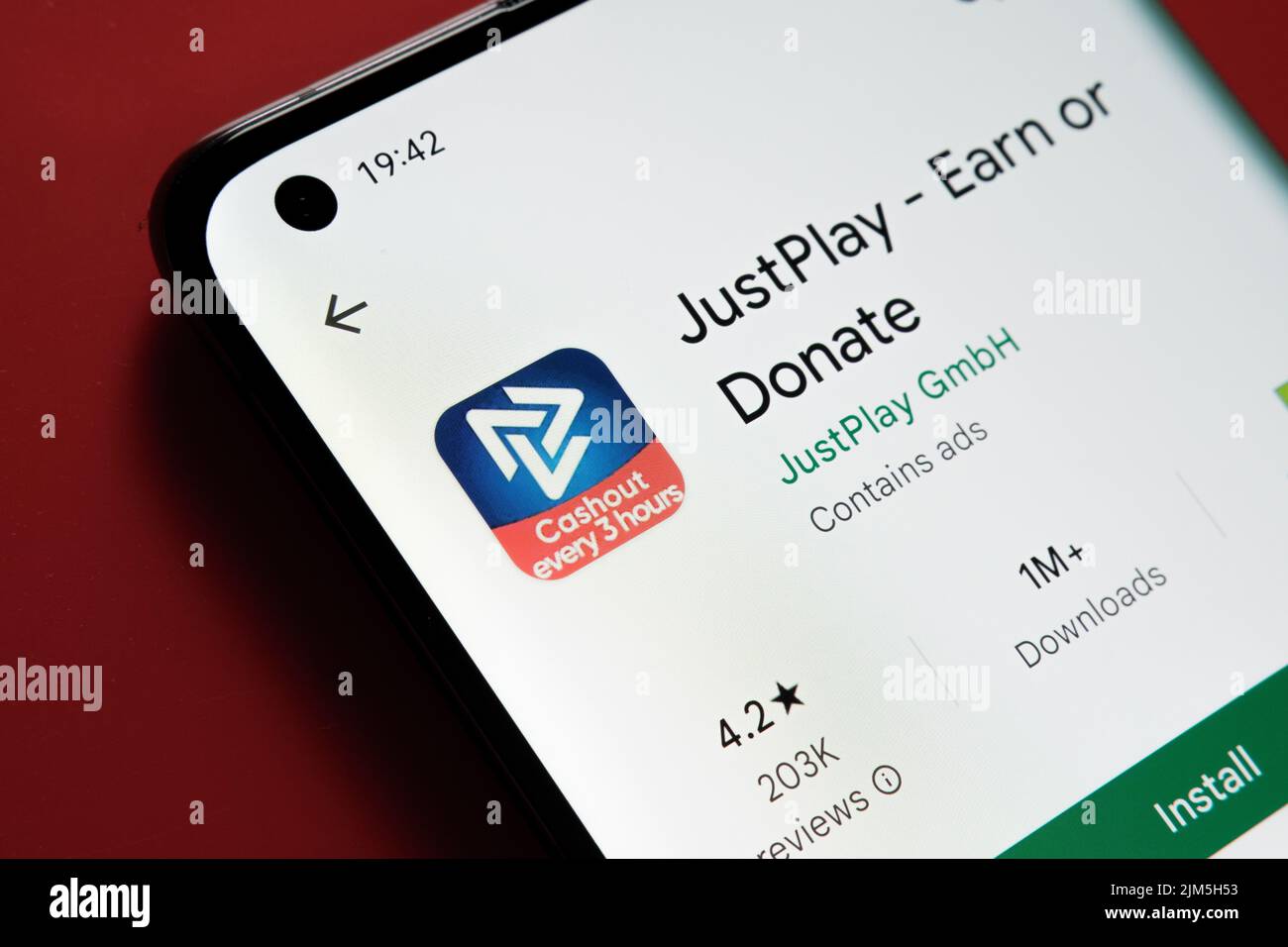 JustPlay app seen in Google Play Store on the smartphone screen placed ...