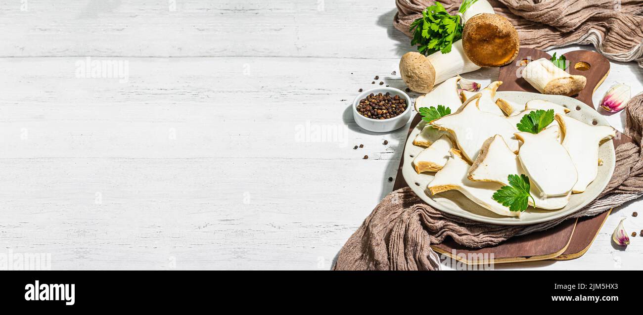 Fresh Pleurotus eryngii mushrooms on white wooden background. Raw king ...
