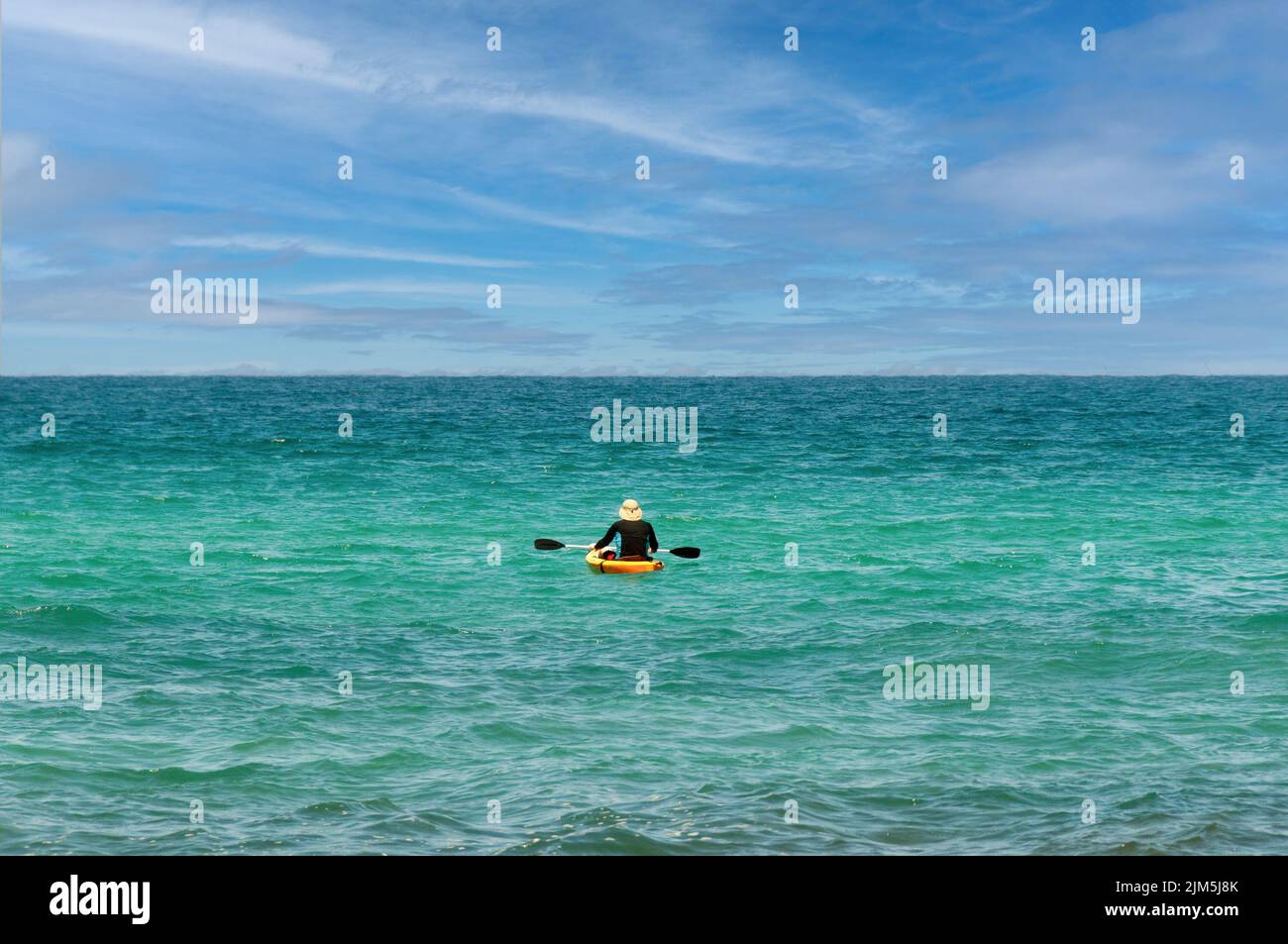 The guy sailed on a kayak into the open sea and sits in a kayak ...