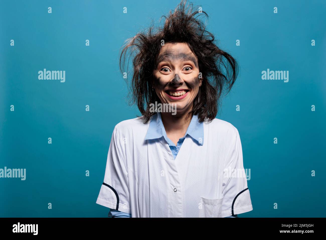 Portrait of crazy chemist with dirty face and messy hair grinning ...