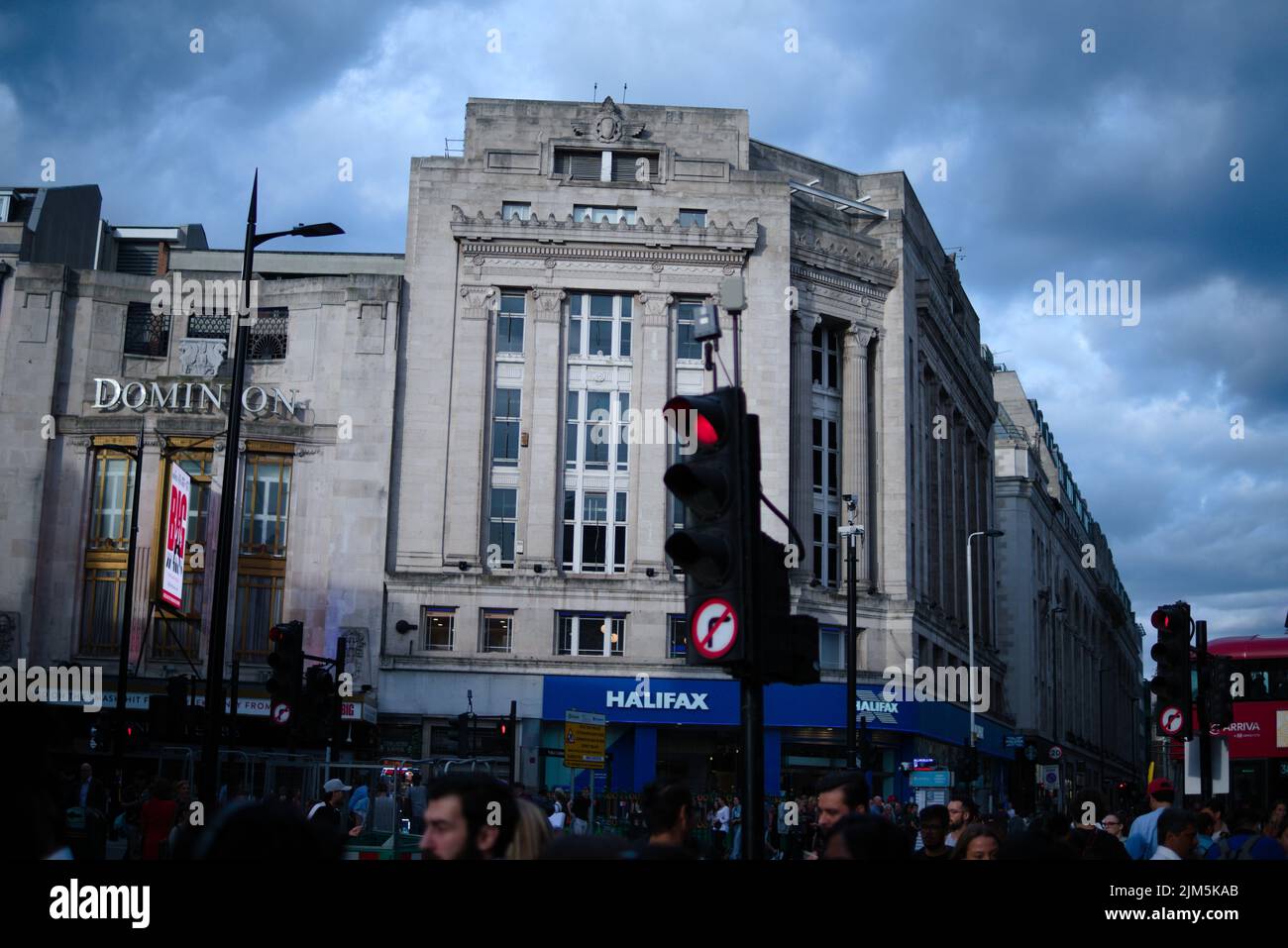 The Dominion's building and traffic lights in a crowded street at the ...