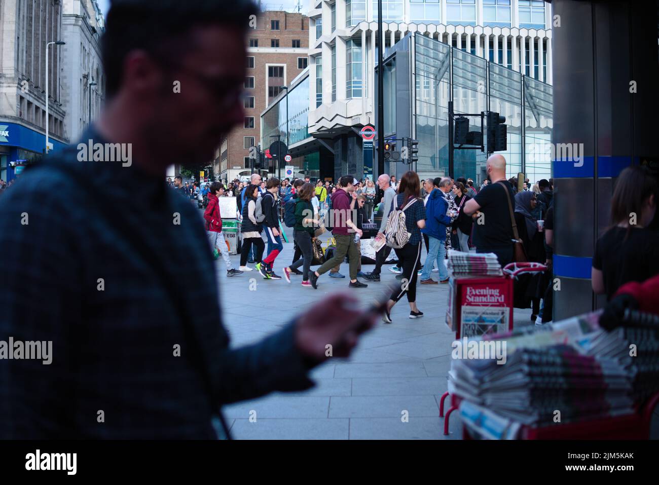 A crowd of people walking on the street of Soho district with modern ...