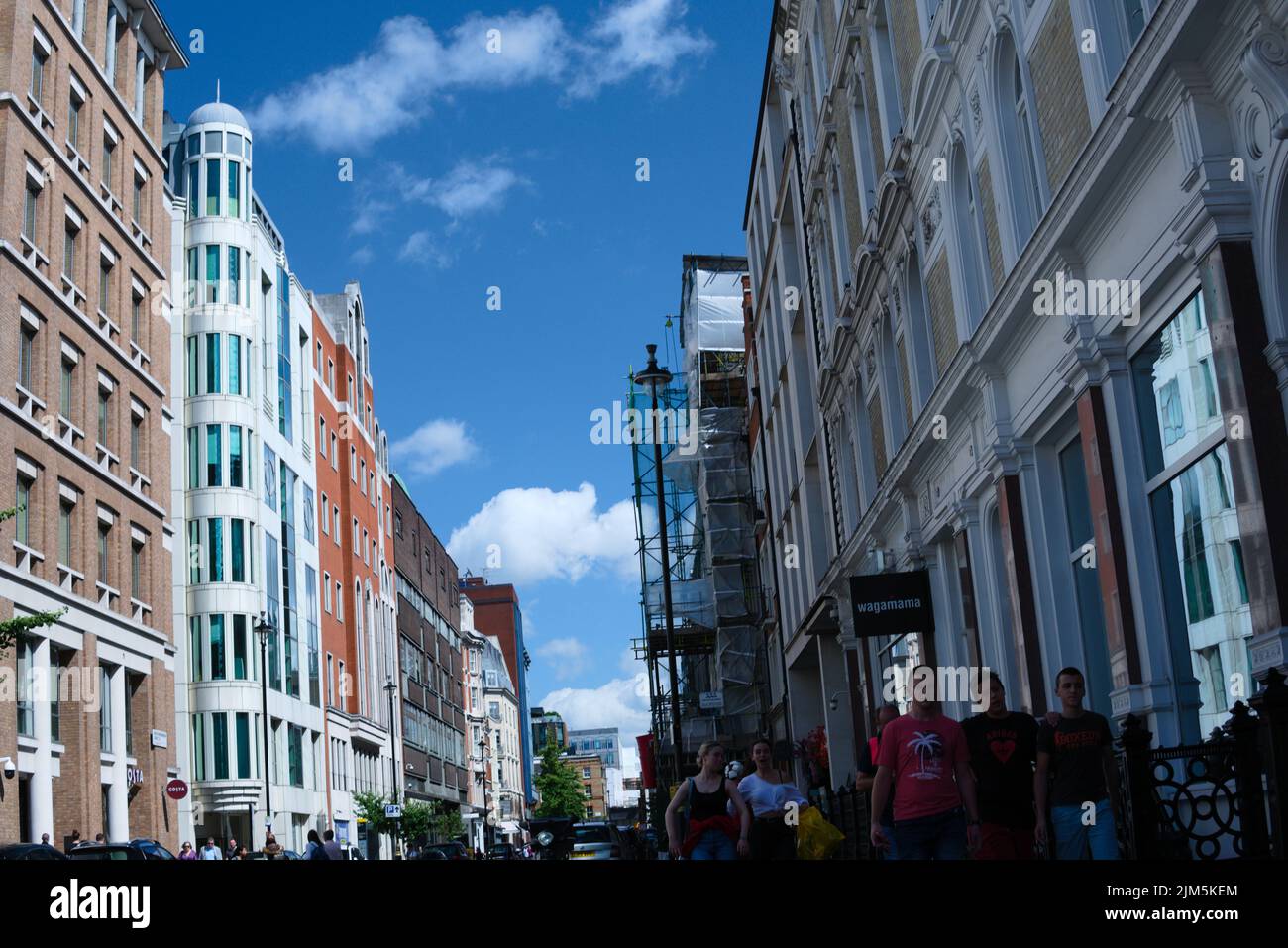 The people walking in the street on a sunny day in Soho, London Stock ...