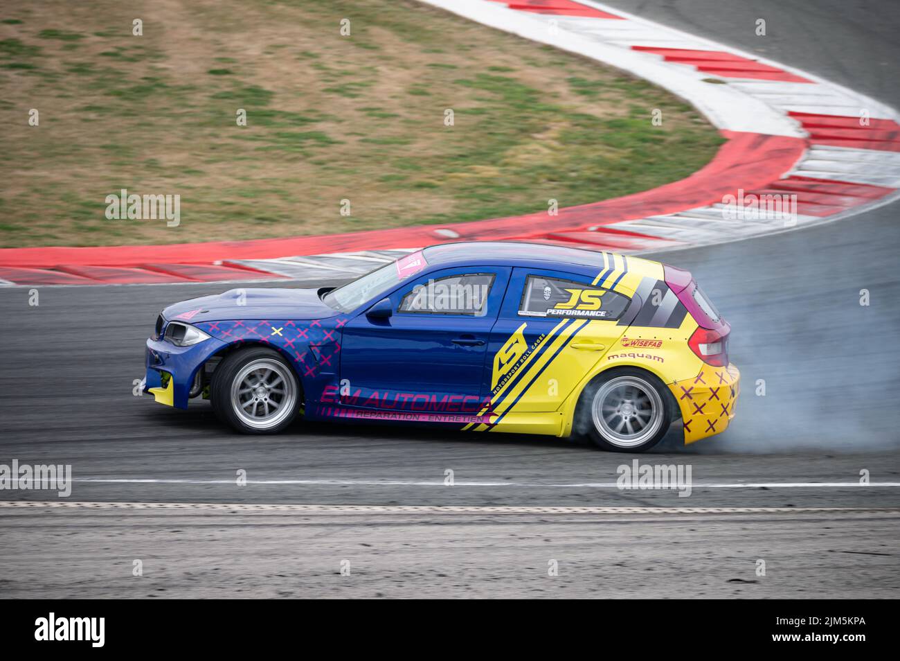 BMW E87 1 Series drifting on the circuit, it is blue and yellow color ...