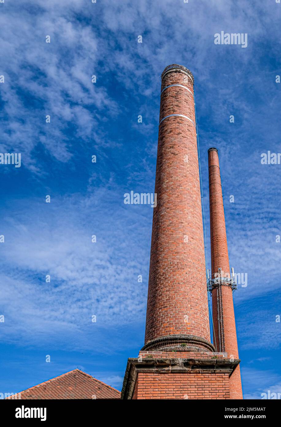 The industrial chimneys tower in the blue sky Stock Photo - Alamy