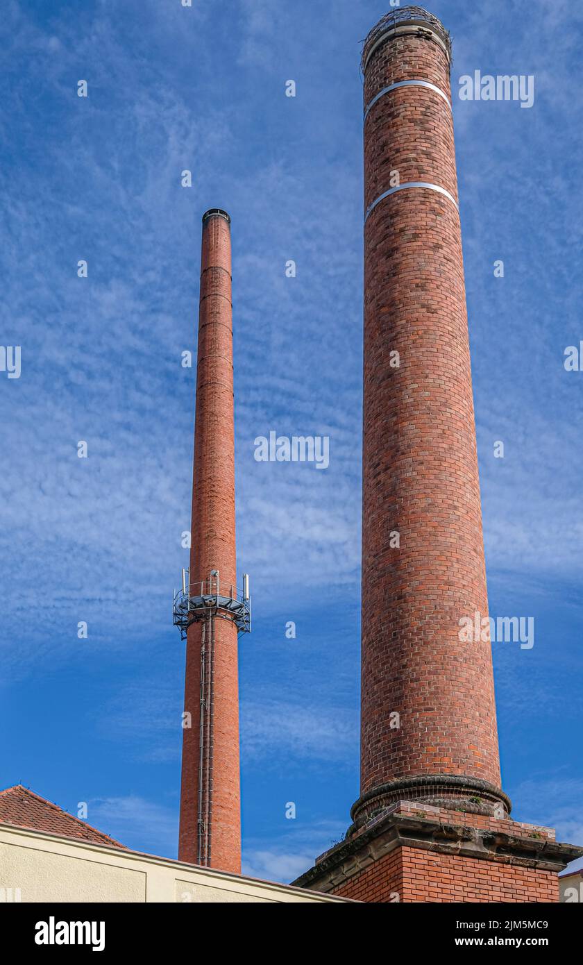 The industrial chimneys tower in the blue sky Stock Photo - Alamy
