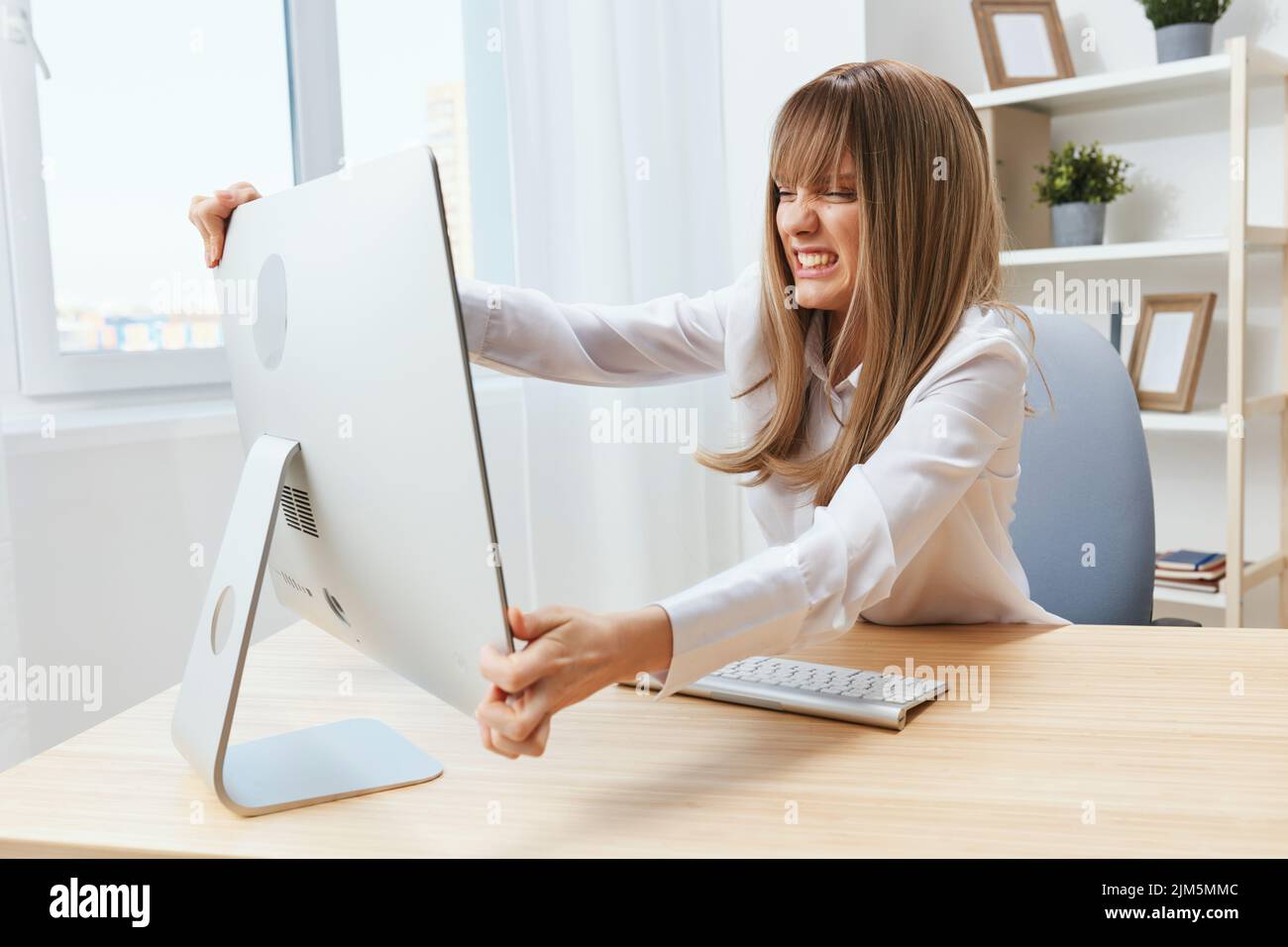 Angry evil blonde businesswoman screaming to desktop Raging after ...