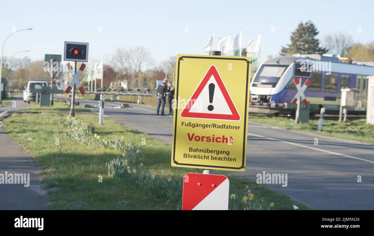 A selective focus shot of a German warning sign warning of the railroad ...