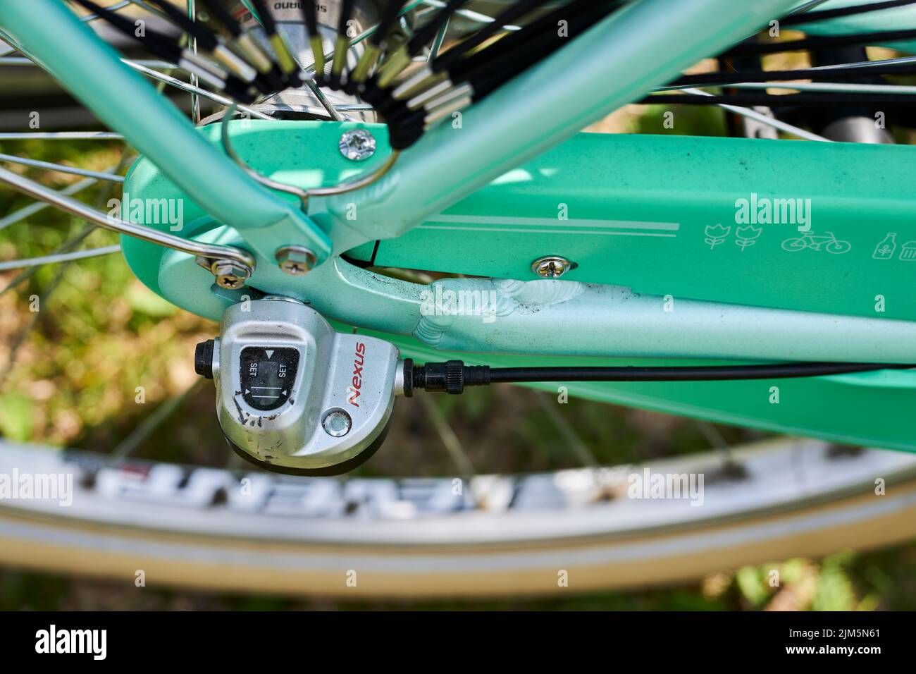 A top view of "Nexus" branded gears on a green bicycle wheel Stock ...