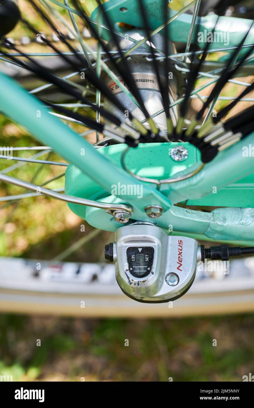 A vertical top view of "Nexus" branded gears on a green bicycle wheel ...