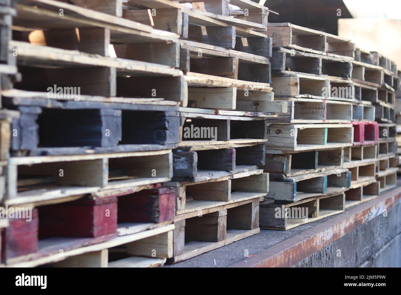 Stacked wooden pallets on shipping dock Stock Photo - Alamy