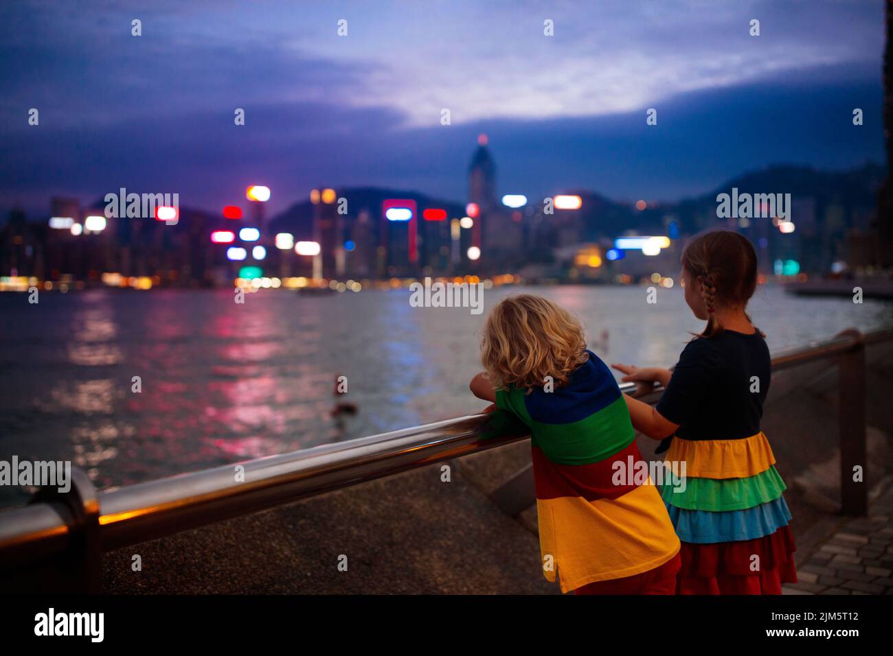 Kids watch Hong Kong harbor skyline at night. Travel with young ...
