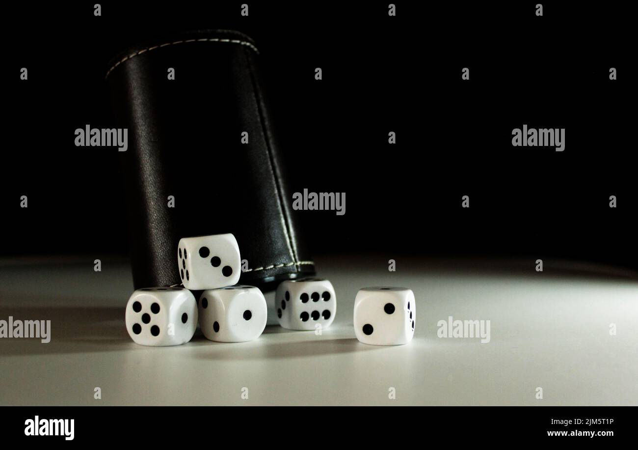 A heap of white dice on a black background Stock Photo - Alamy