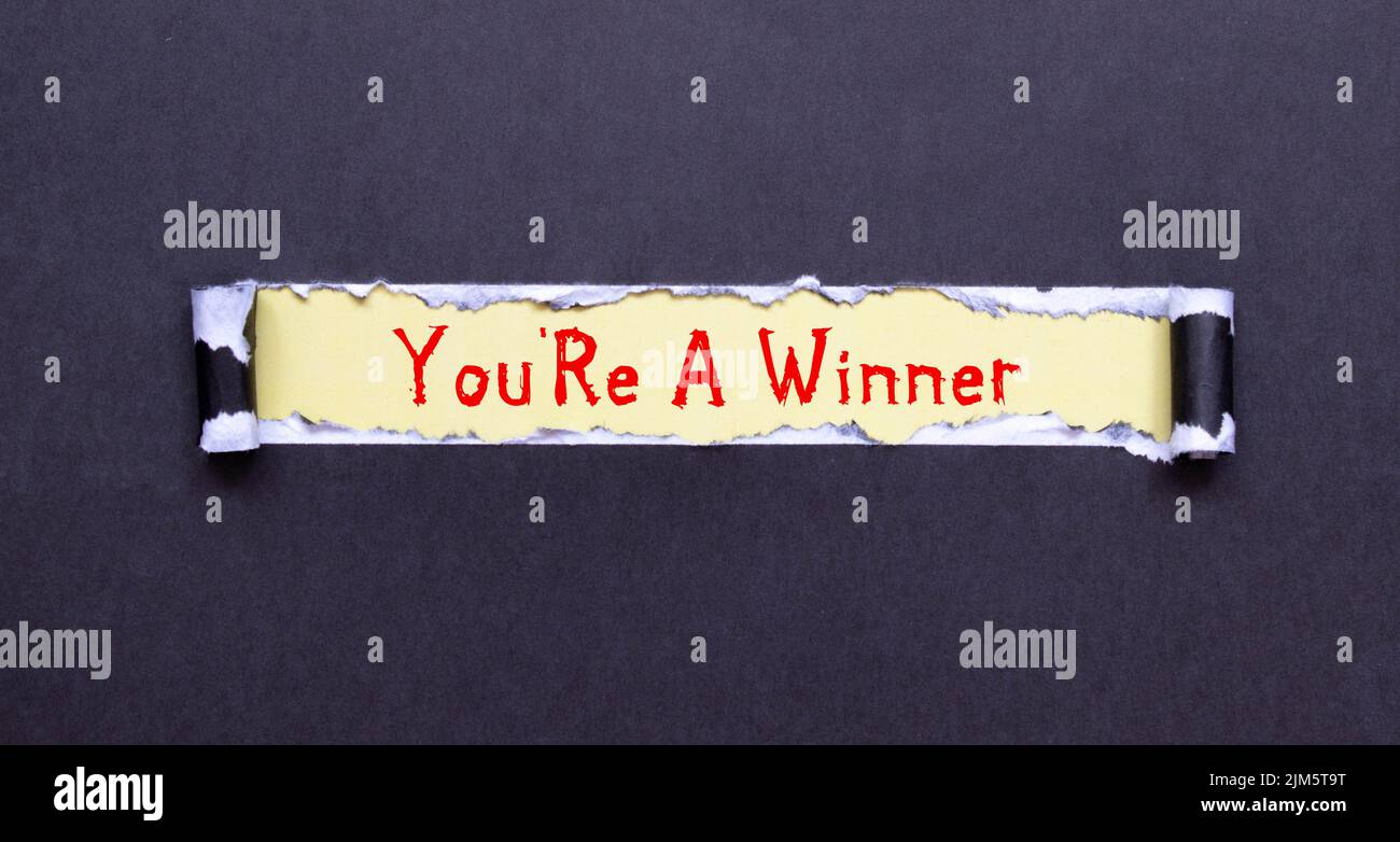 white paper with text You Re A Winner on a yellow background with ...