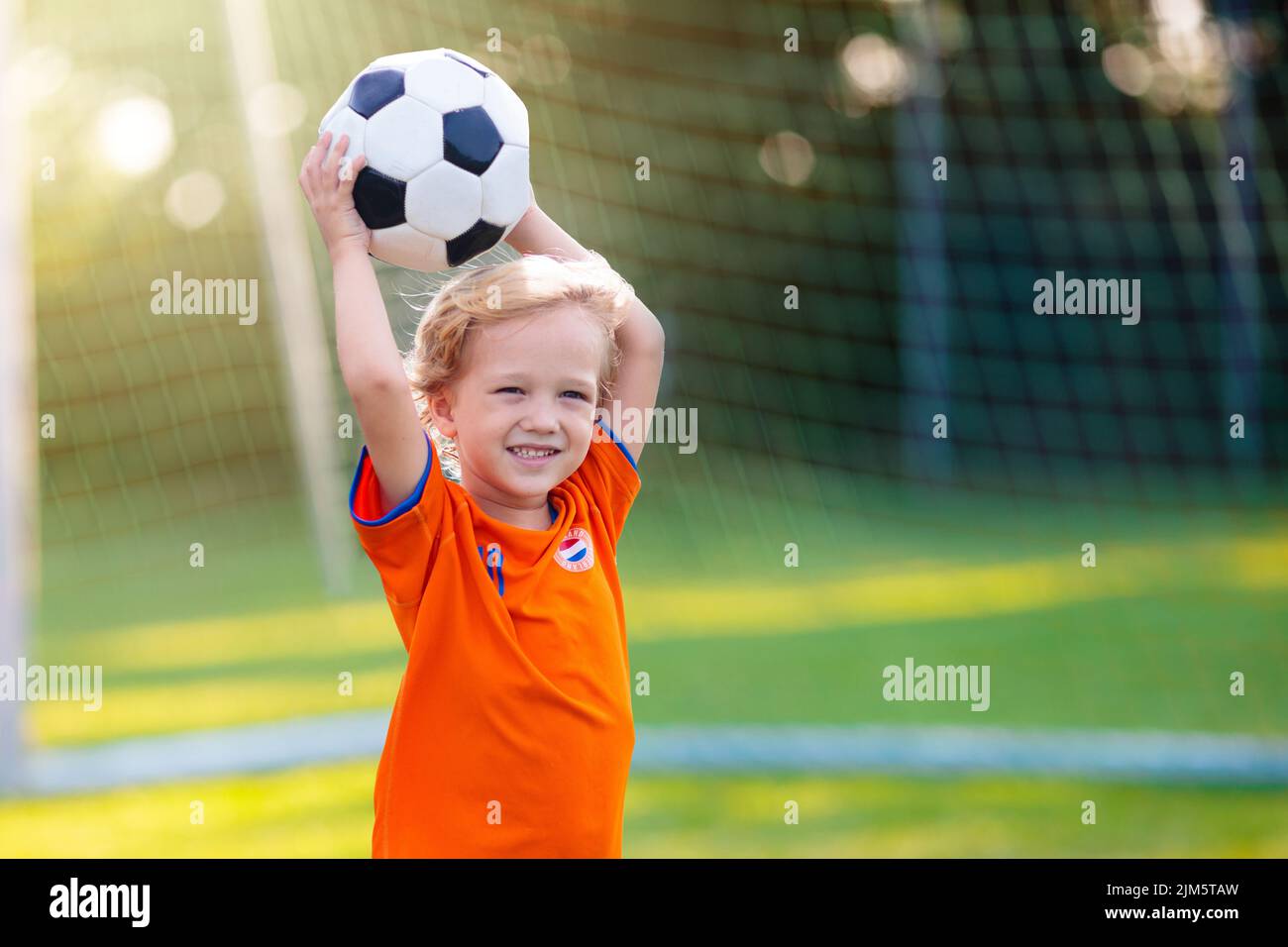 Dutch kids play football on outdoor field. Netherlands team fans with ...