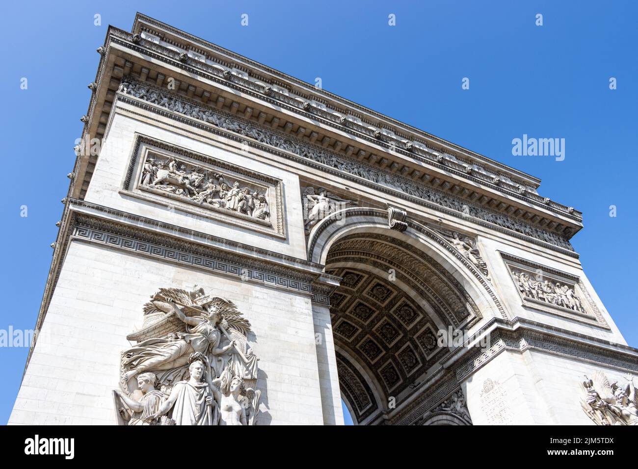 A low angle shot of the L'arc de Triomphe in Paris, France Stock Photo ...