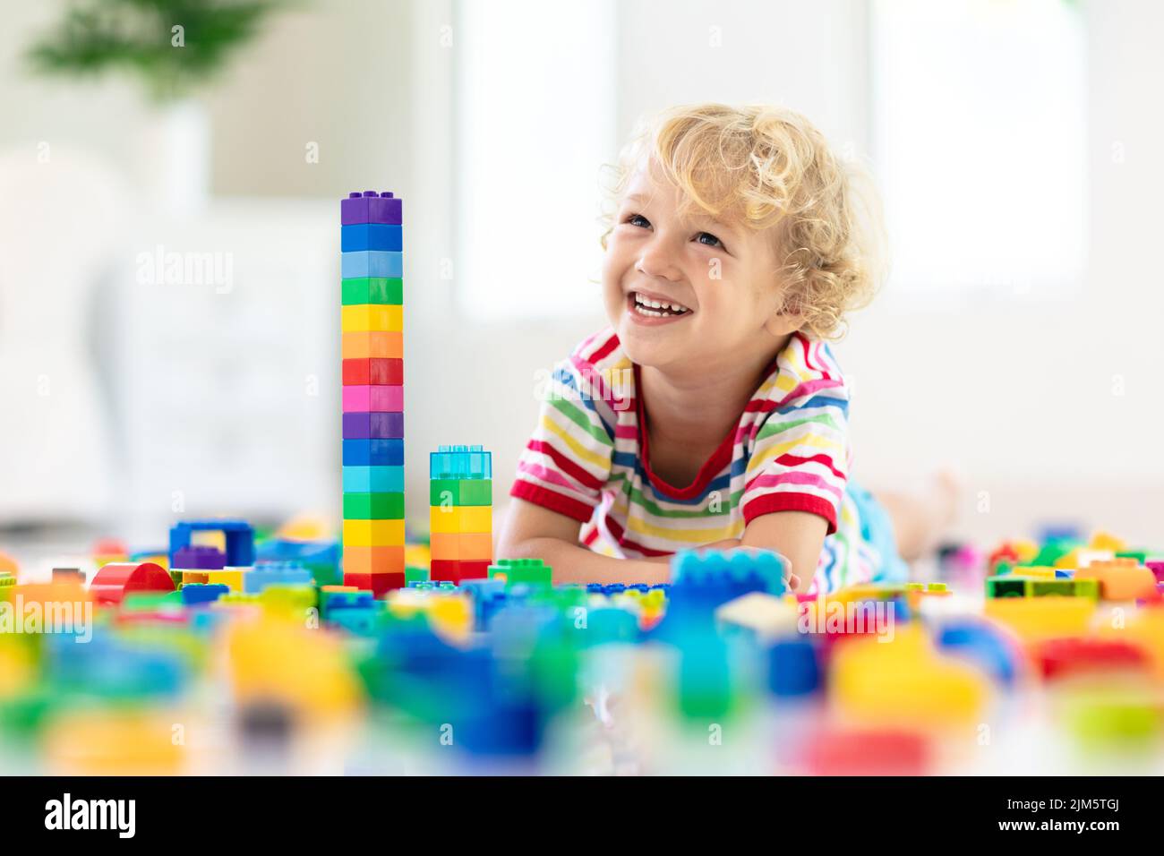 Child playing with colorful toy blocks. Little boy building tower at ...