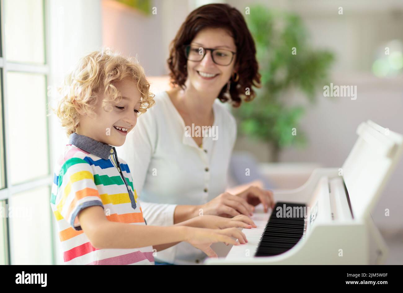 Child playing piano. Kids play music. Classical education for children ...