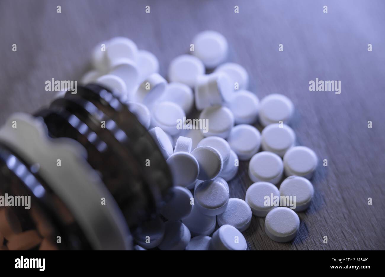 Pills in a bottle, white tablets medication for serious illness and ...