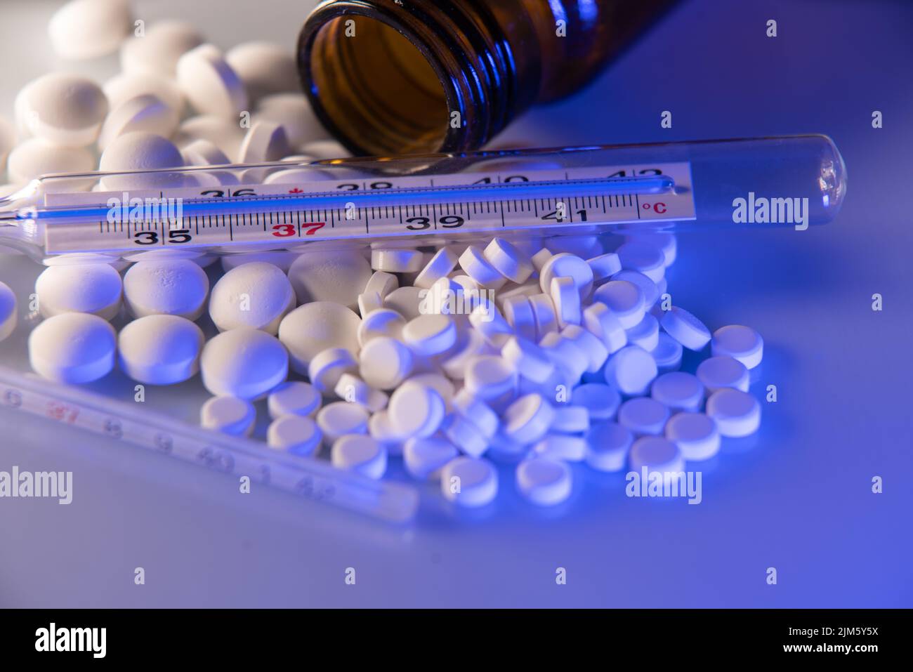 Mercury Rising Thermometer on white Pills. Medicine and Drugs for ...