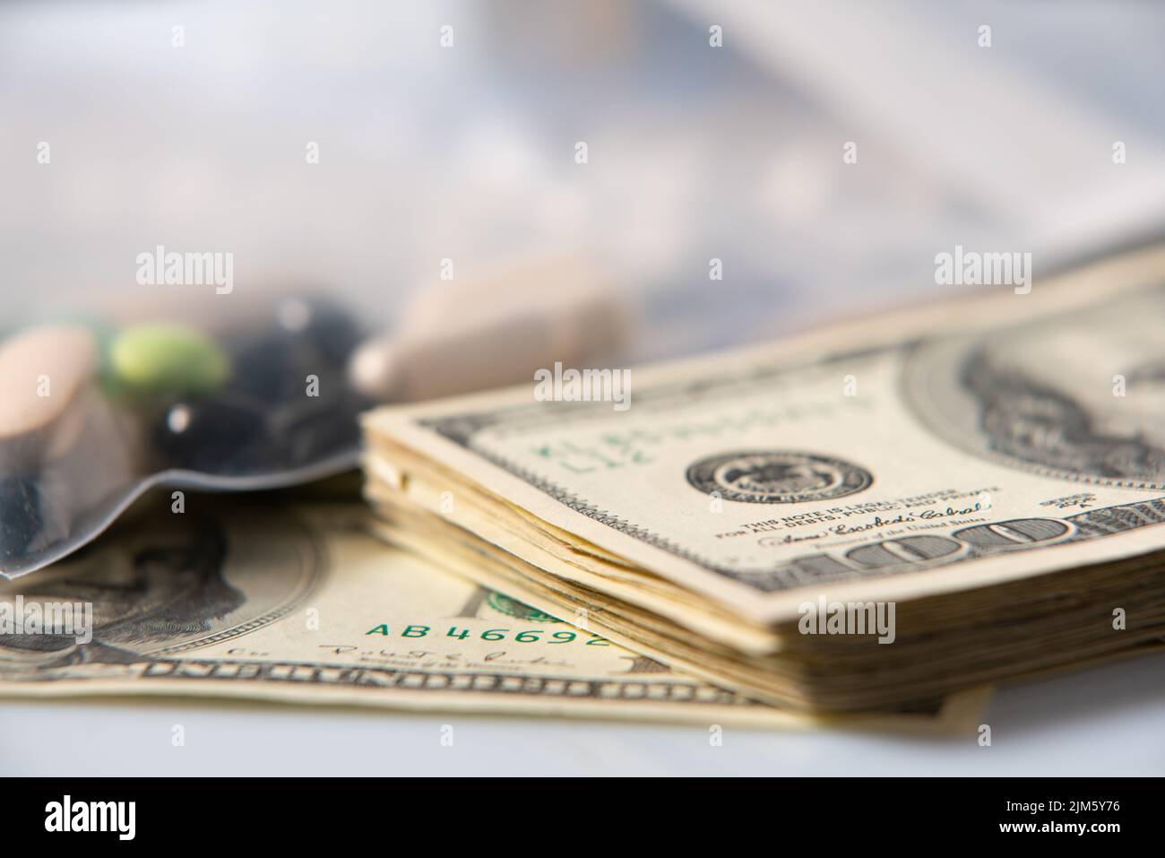 Dollar Bills and Pills. Drugs in plastic bag with cash money. Illegal ...