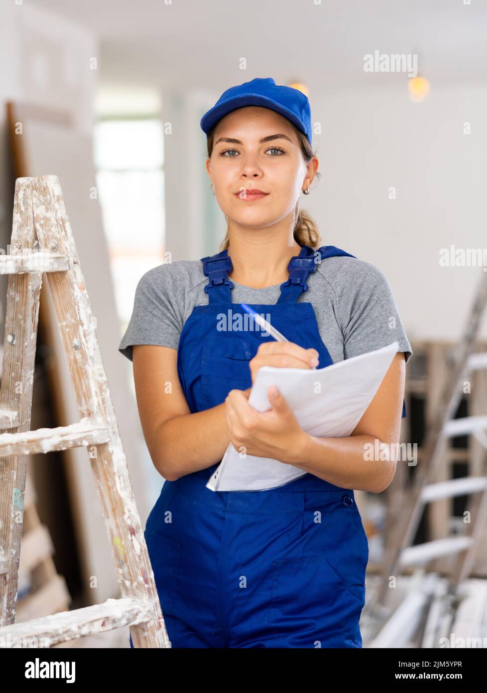 Woman foreman checks the completed construction work on drawing Stock ...