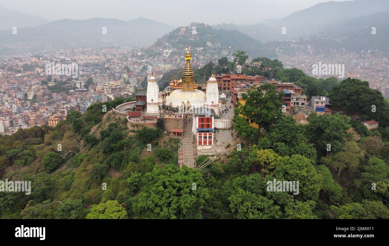 A bird's eye view of the Swayambhu religious complex in bright sunlight ...