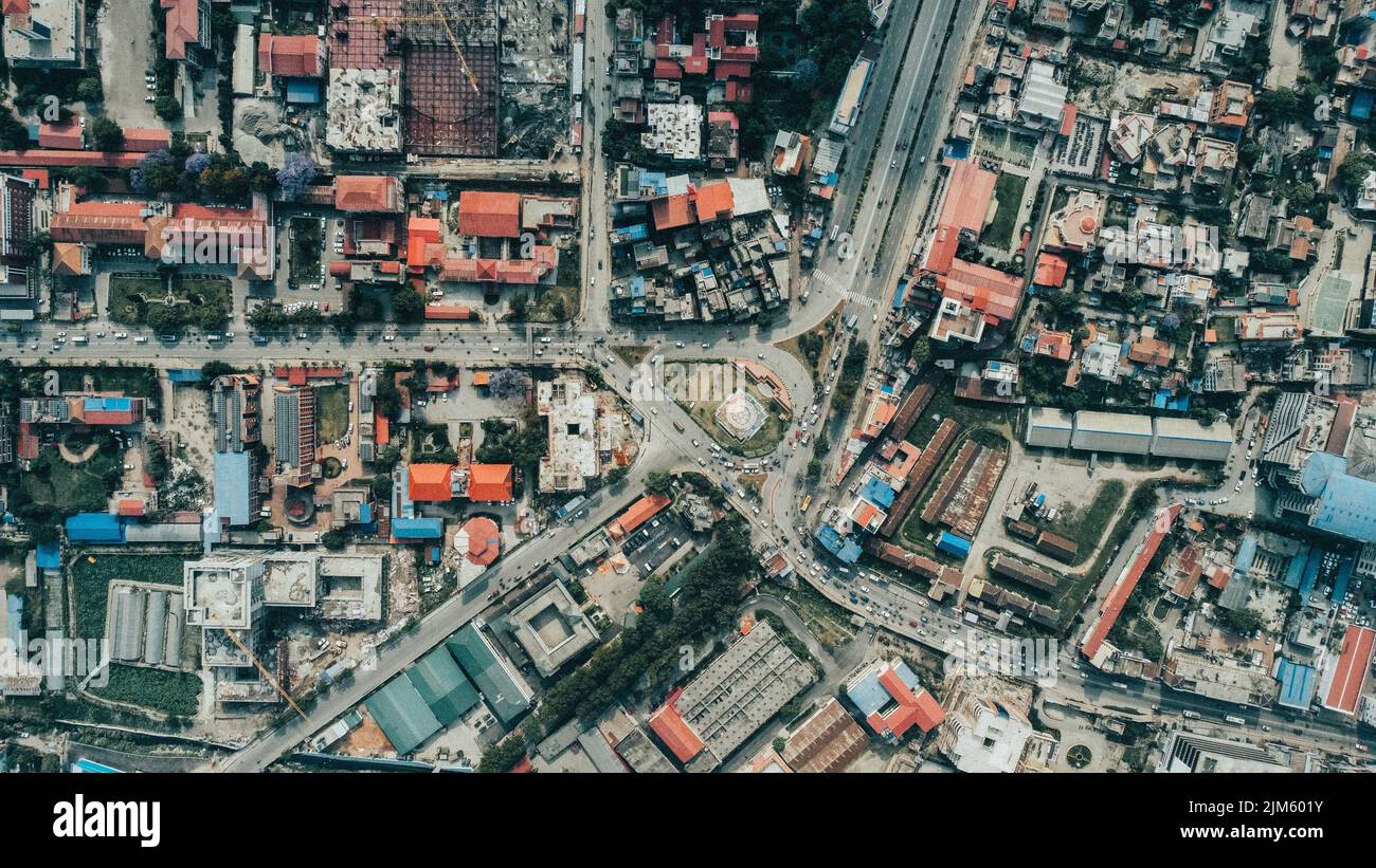 An aerial view of the Maitighar Mandala monument and buildings around in bright sunlight in ...
