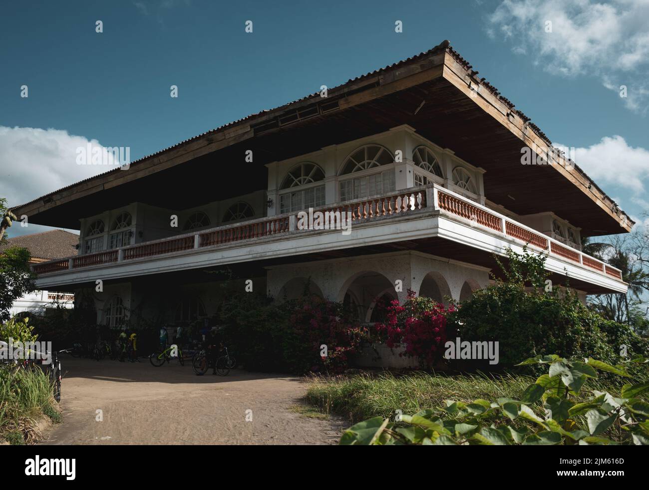 A picturesque view of the Marcos Twin Mansion on blue cloudy sky ...