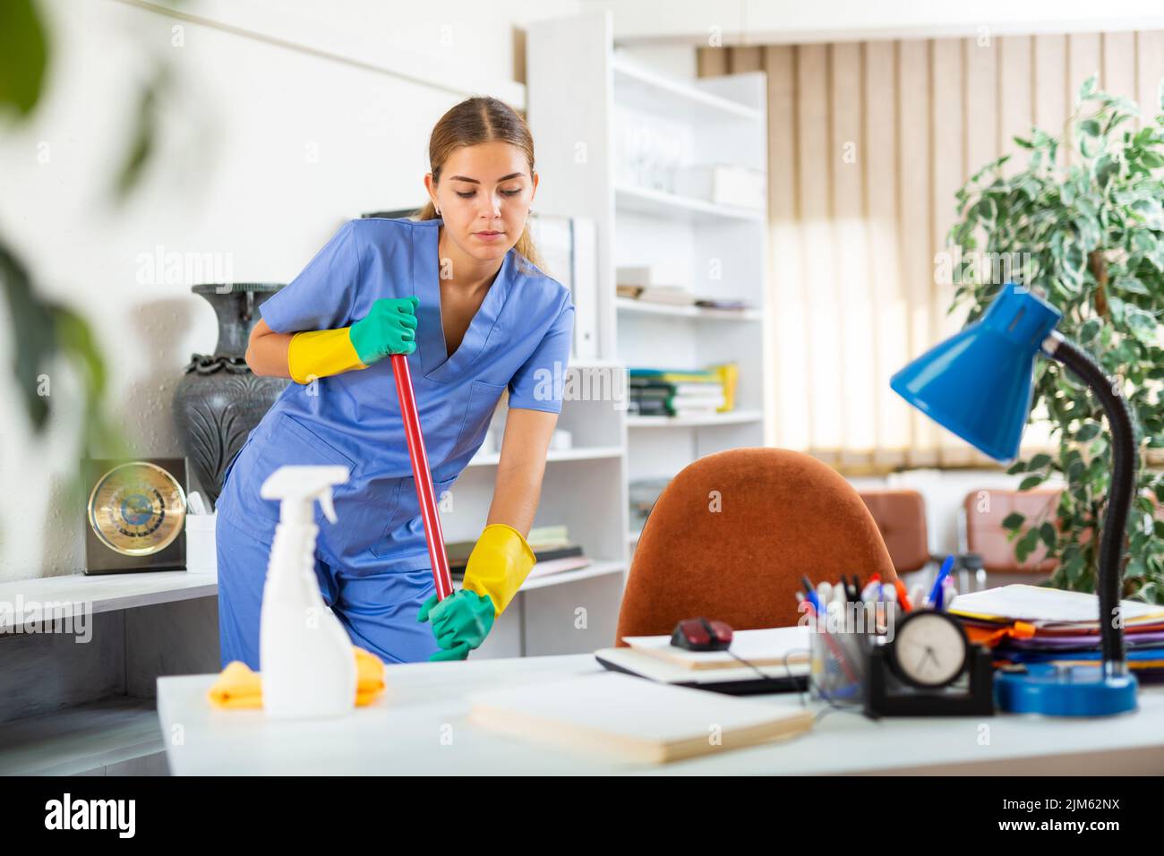 Female worker of office cleaning service wiping floors with mop Stock ...