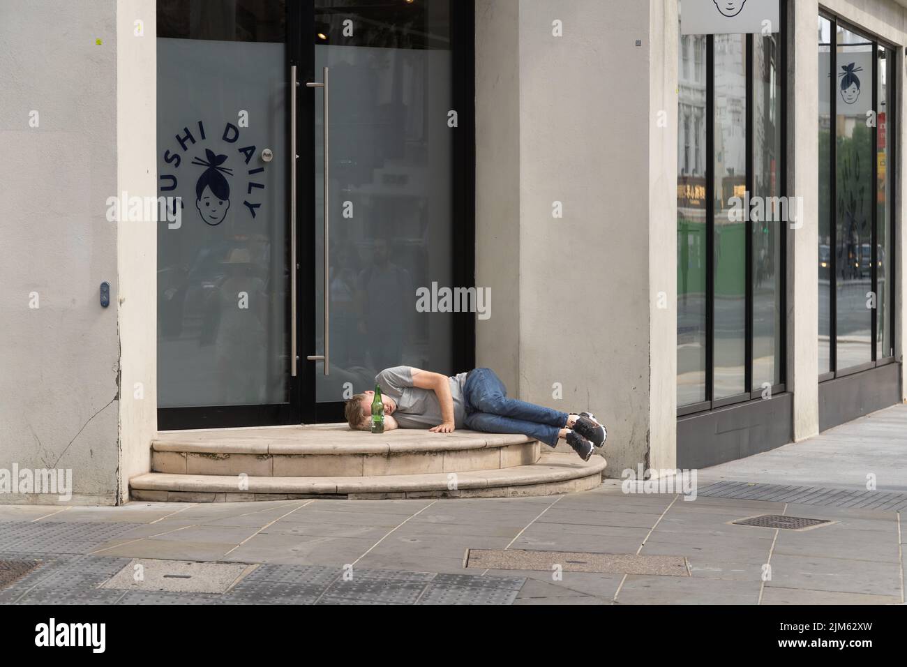 Unconscious drunk man Stock Photo - Alamy