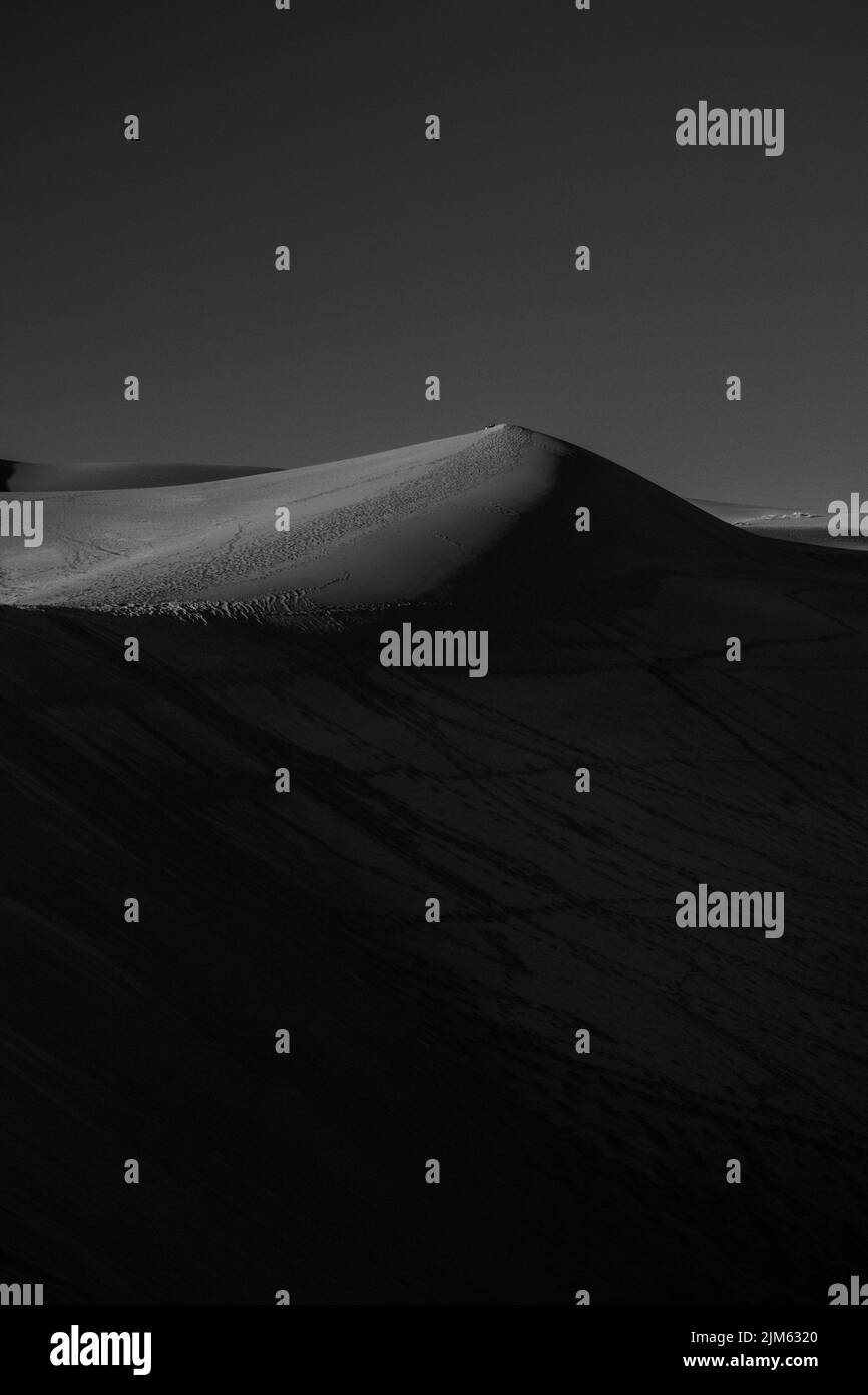 a vertical shot of sand hill in desert in grayscale Stock Photo - Alamy