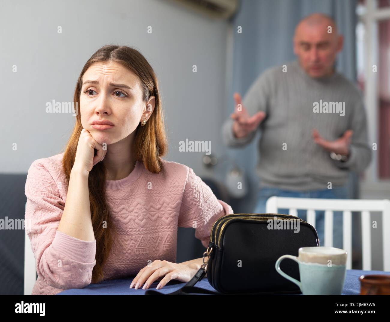 Portrait of a frustrated woman, while husband scolds her Stock Photo ...