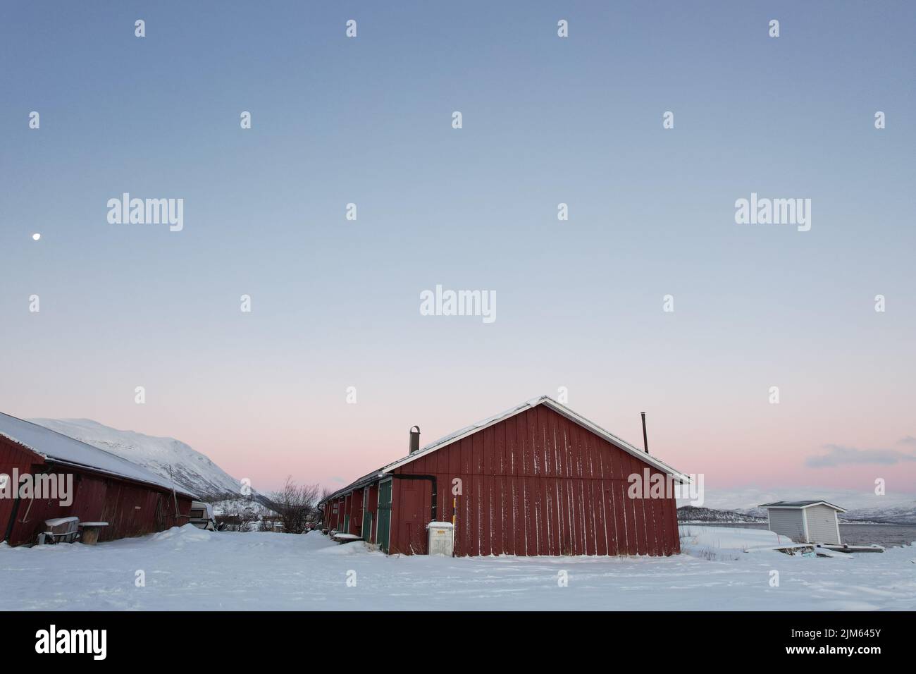 A red farm barn in winter on a sunset sky background Stock Photo - Alamy