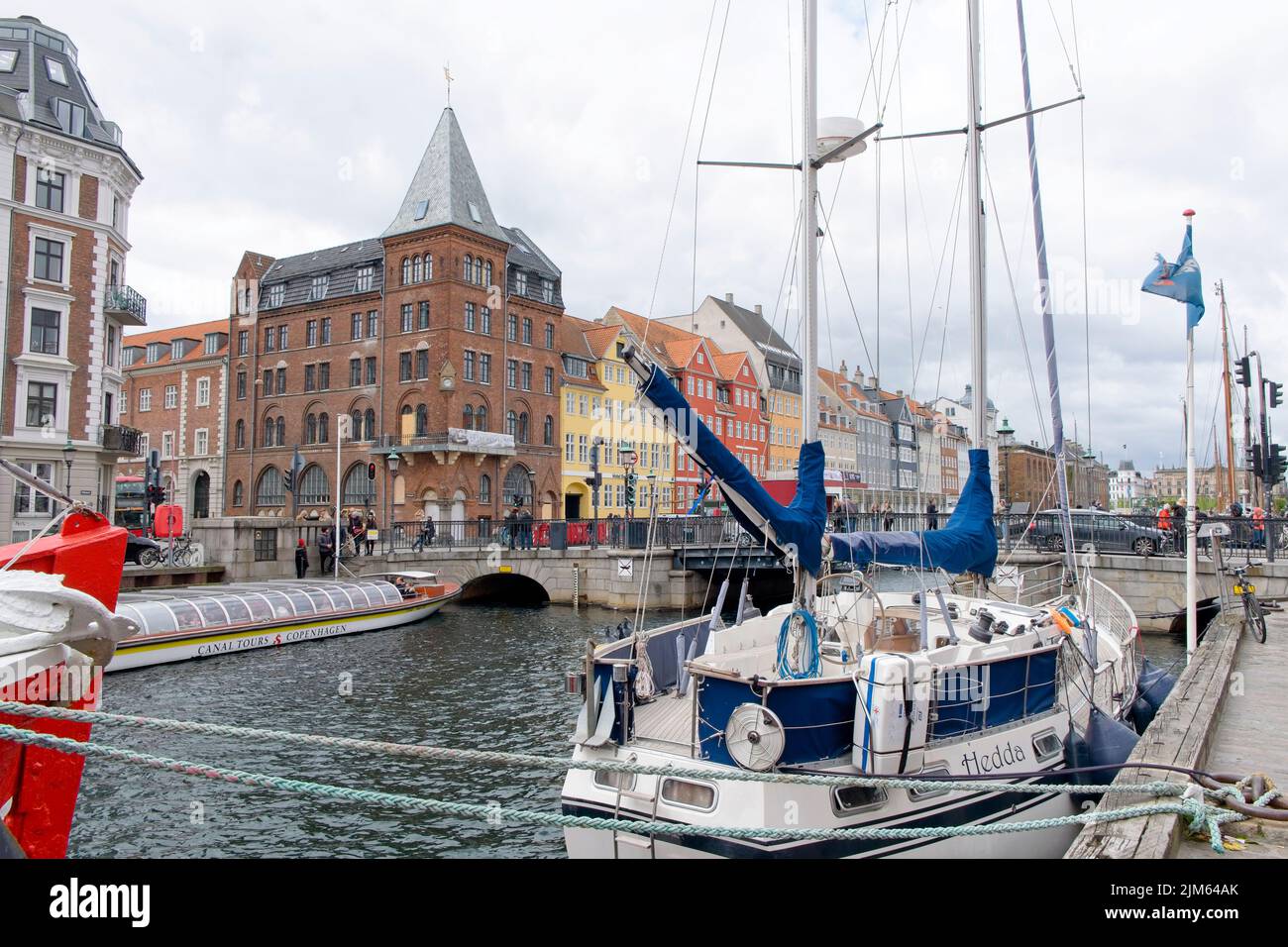 Yachts and tour boats moored in the waterways Nyhavn, Copenhagen ...