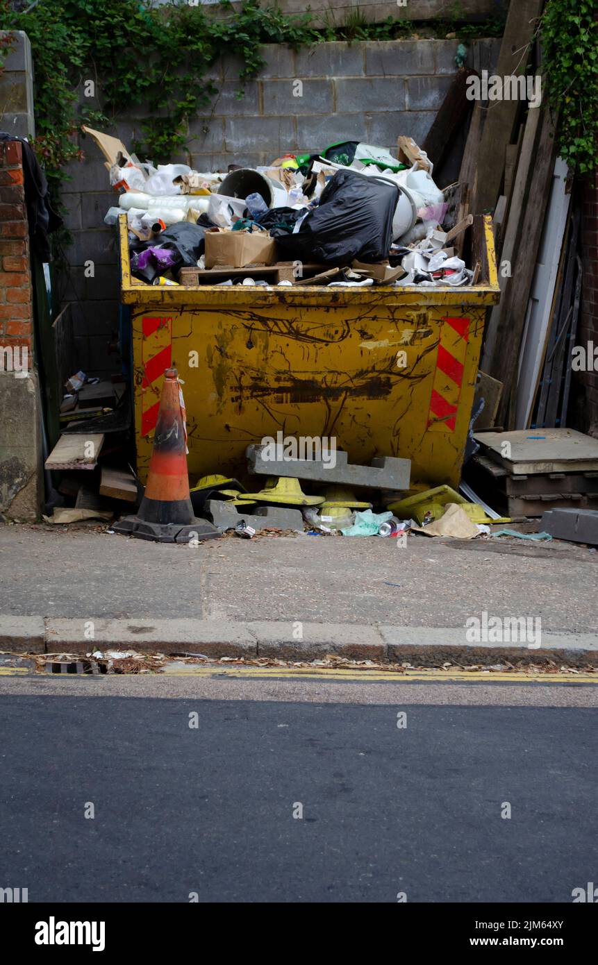 Overflowing rubbish skip hi-res stock photography and images - Alamy