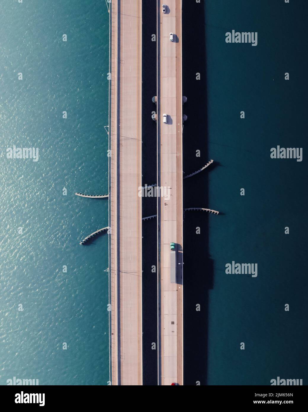 An aerial top view of cars passing over bridges built on the water ...