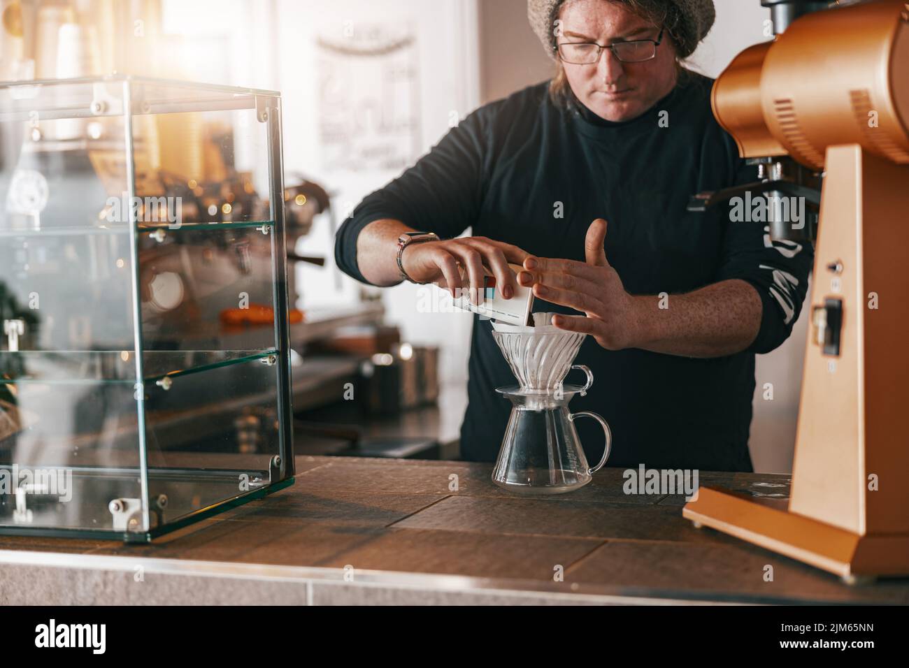 Men barista making a drip filter coffee standing by counter in ...
