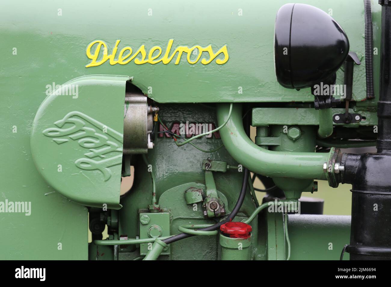 this close-up shows part of the bonnet in fendt green with the yellow ...