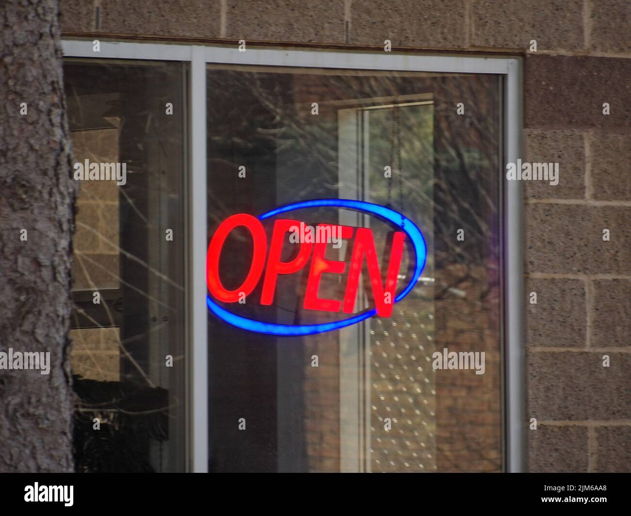 A lit up neon sign open turned on signage Stock Photo - Alamy