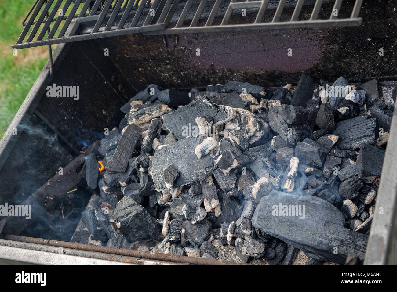 Home barbecue with charcoal in the backyard grilling steaks and other ...