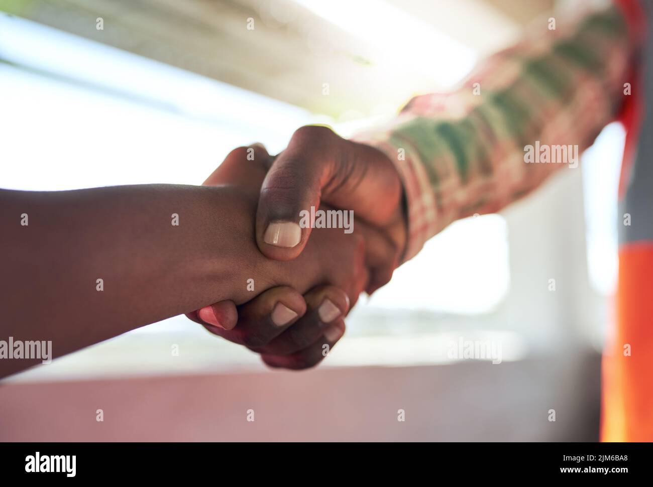 The best partner is a trusted partner. two builders shaking hands at a ...