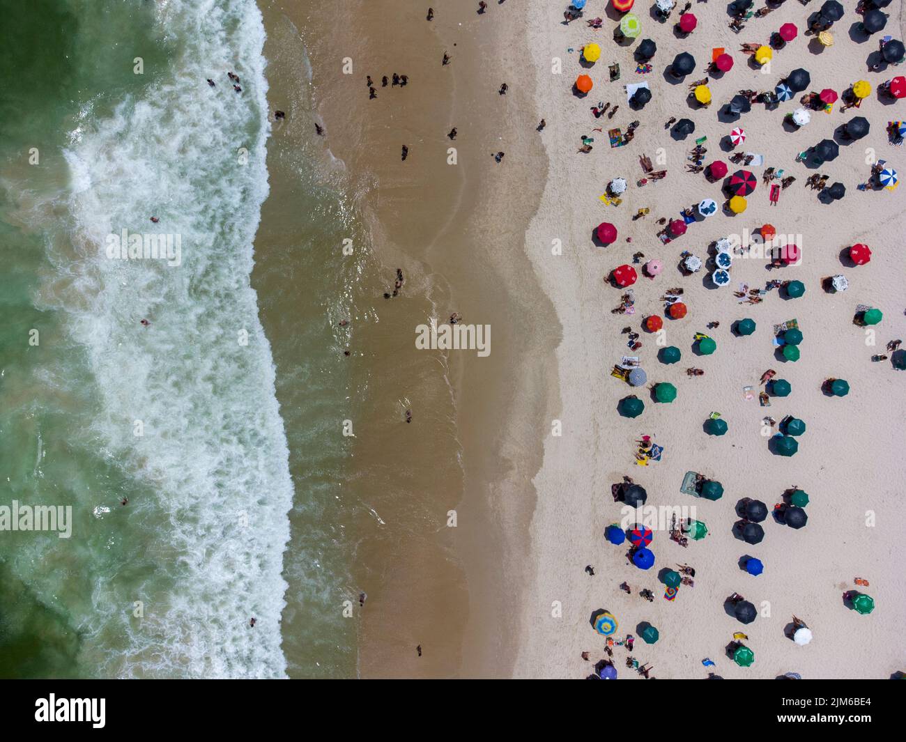An aerial view of the beach and people swimming and relaxing Stock ...