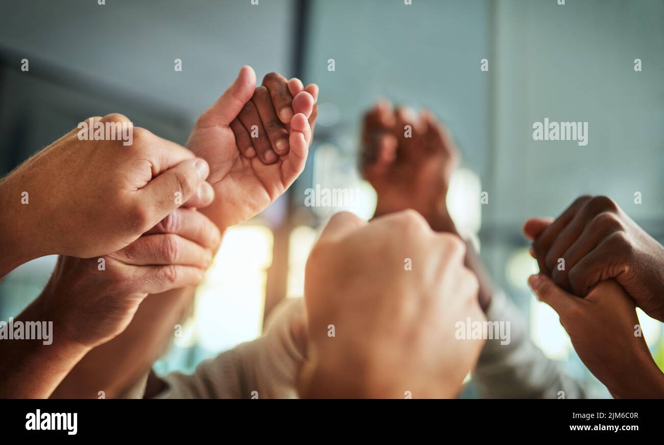 Diverse people holding hands in teamwork, success and support while ...