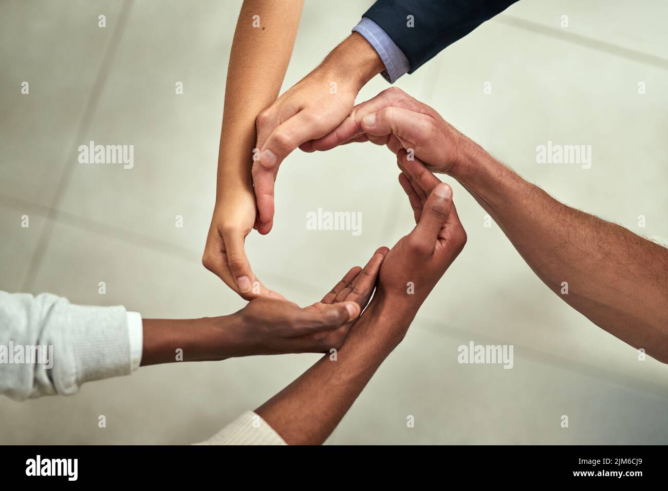 Group of businesspeople hands making creative circle shape together in ...