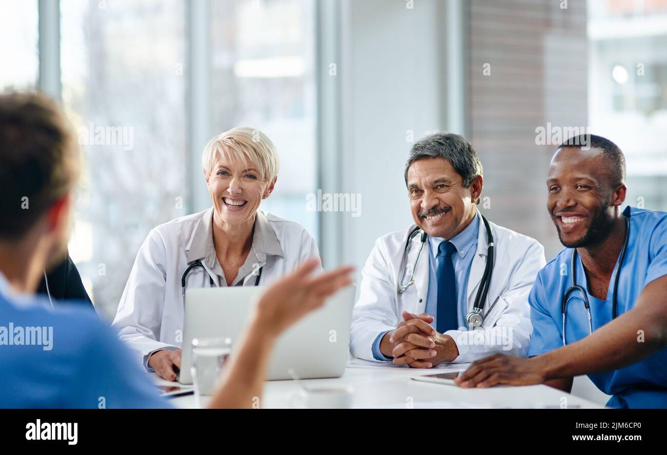 Unity, teamwork and happy health care workers having a meeting in a ...
