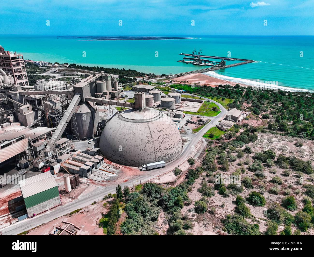 A view of a factory on the beach Stock Photo - Alamy