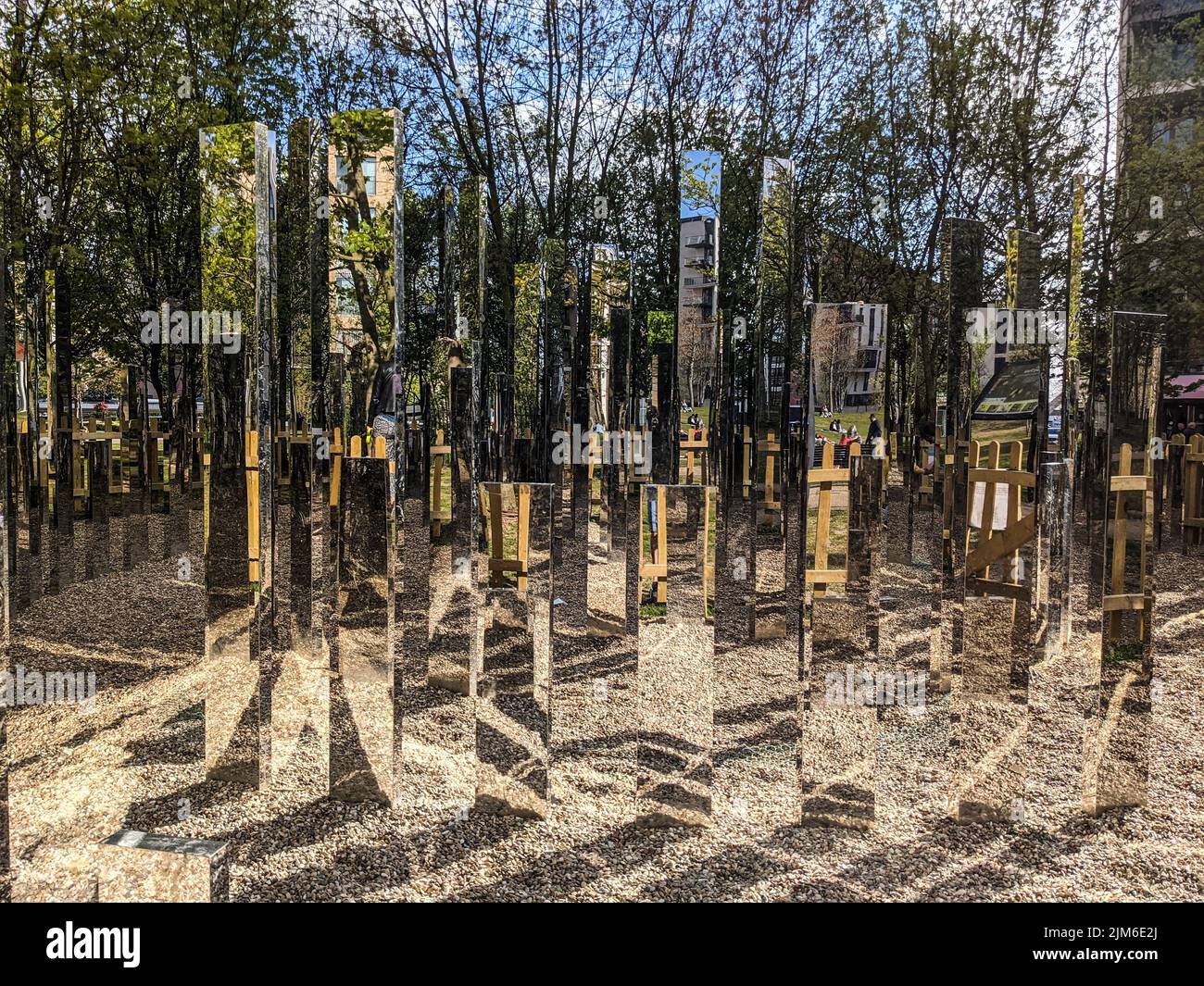A many Pillers of a mirror material reflecting the park around them ...