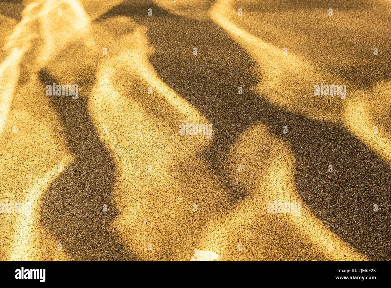 A beautiful shot of lights reflected on an asphalt pavement by a mirror ...