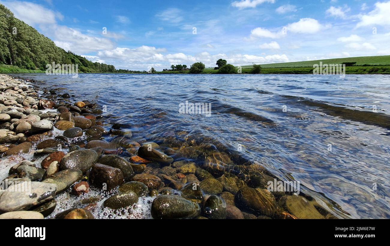 A natural view of the rocky riverside of Tweed river near Berwick in ...